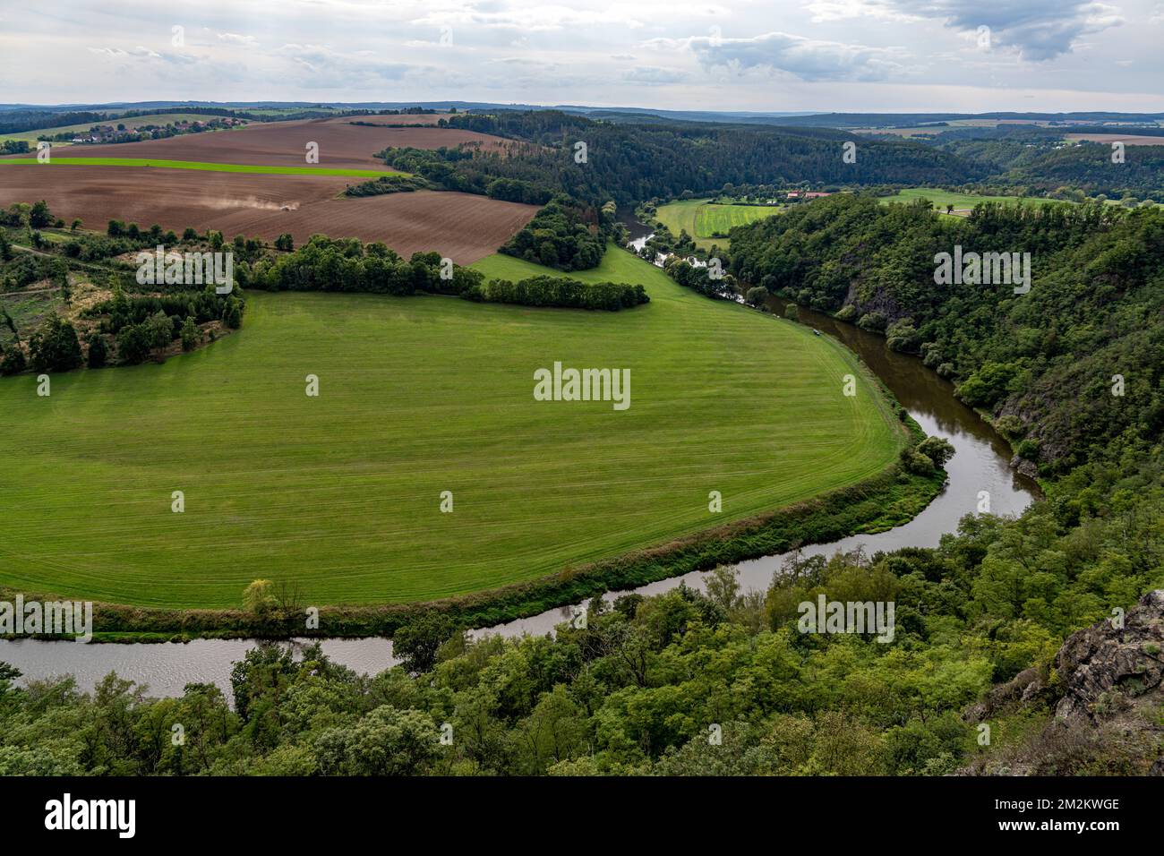 The Berounka river between mountains covered in forests in the Czech ...