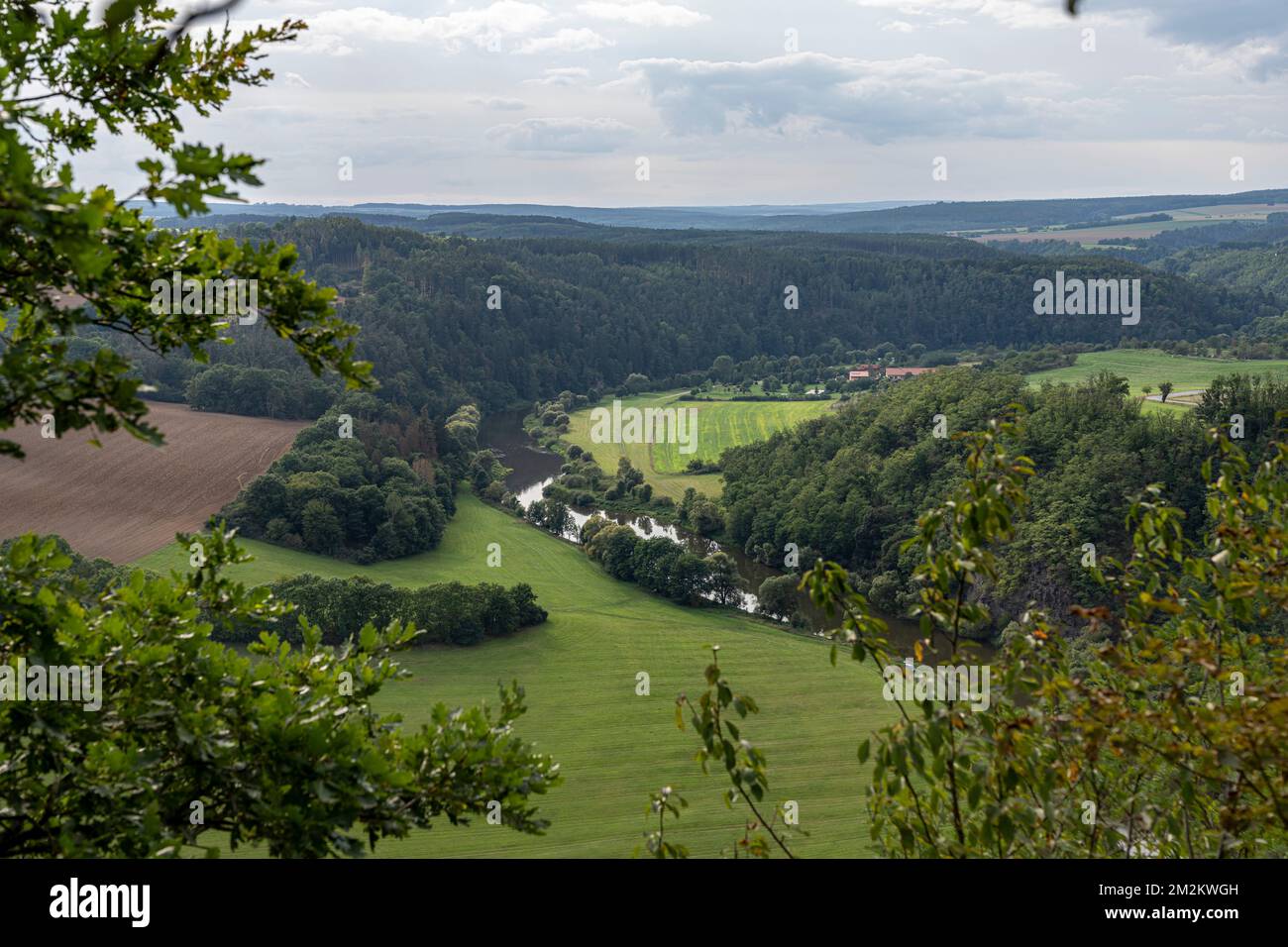 The Berounka river between mountains covered in forests in the Czech ...