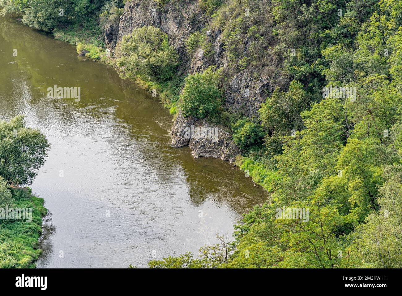 The Berounka river between mountains covered in forests in the Czech ...
