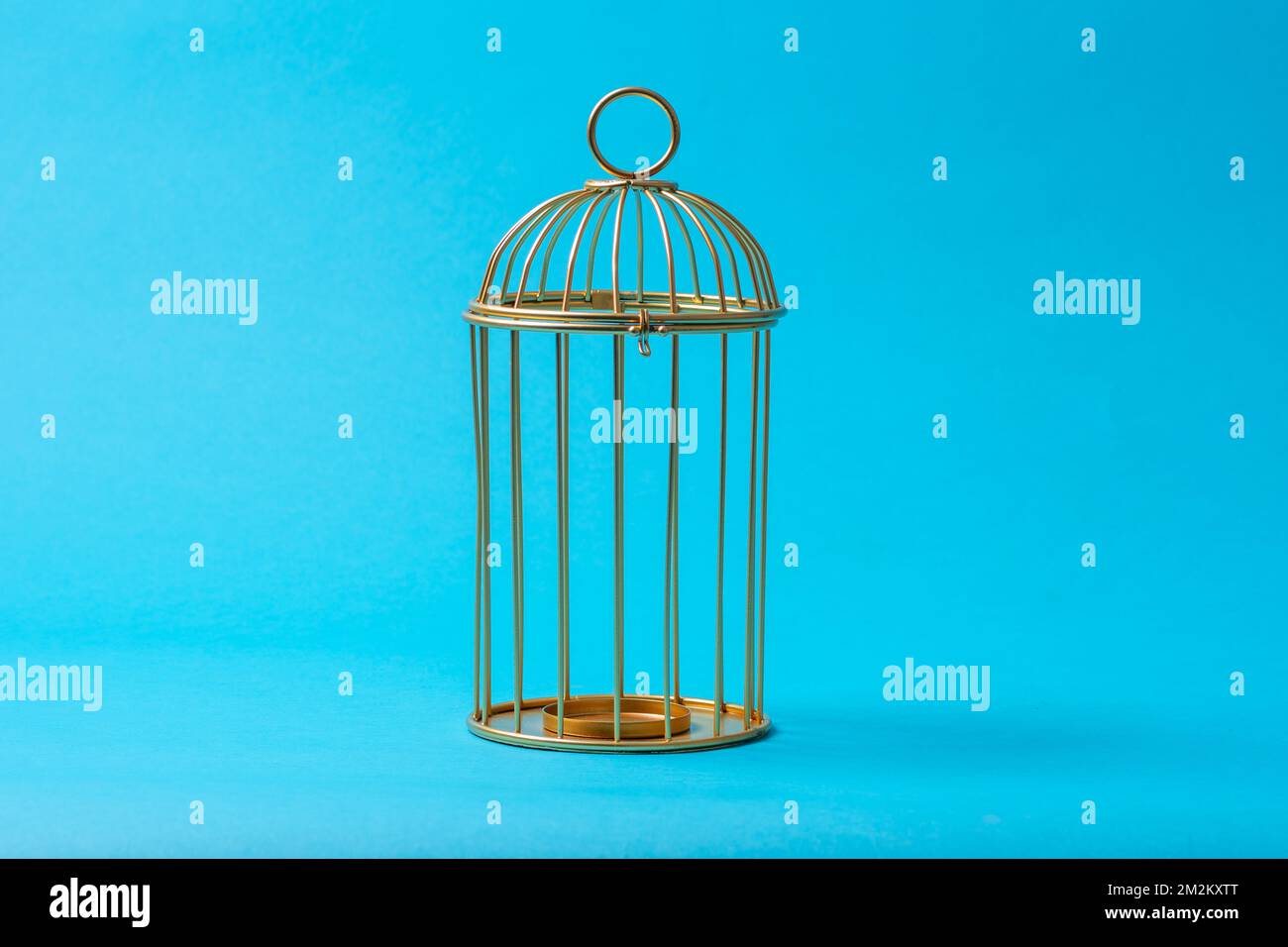 Closed golden cage on a blue background. The concept of change. Comfort ...
