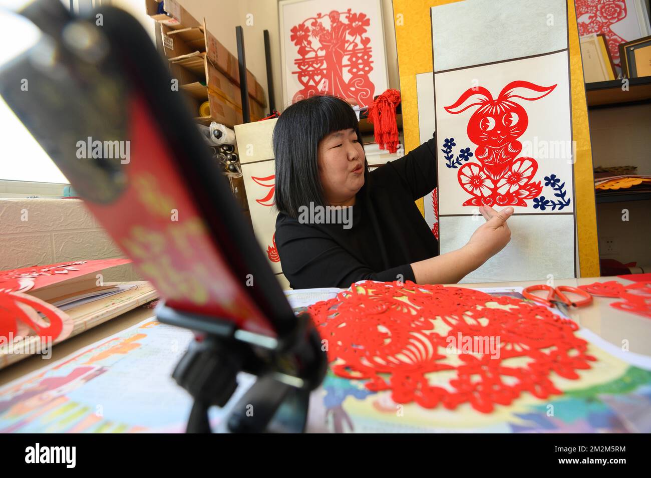 Mrs Wu, a primary school teacher and paper-cutting artist, designs ...