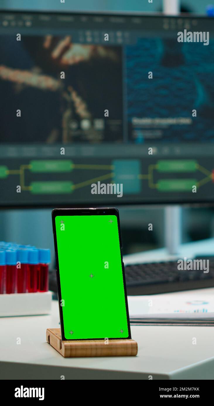 Smartphone with green screen working in laboratory with mock up, chroma key display while ...