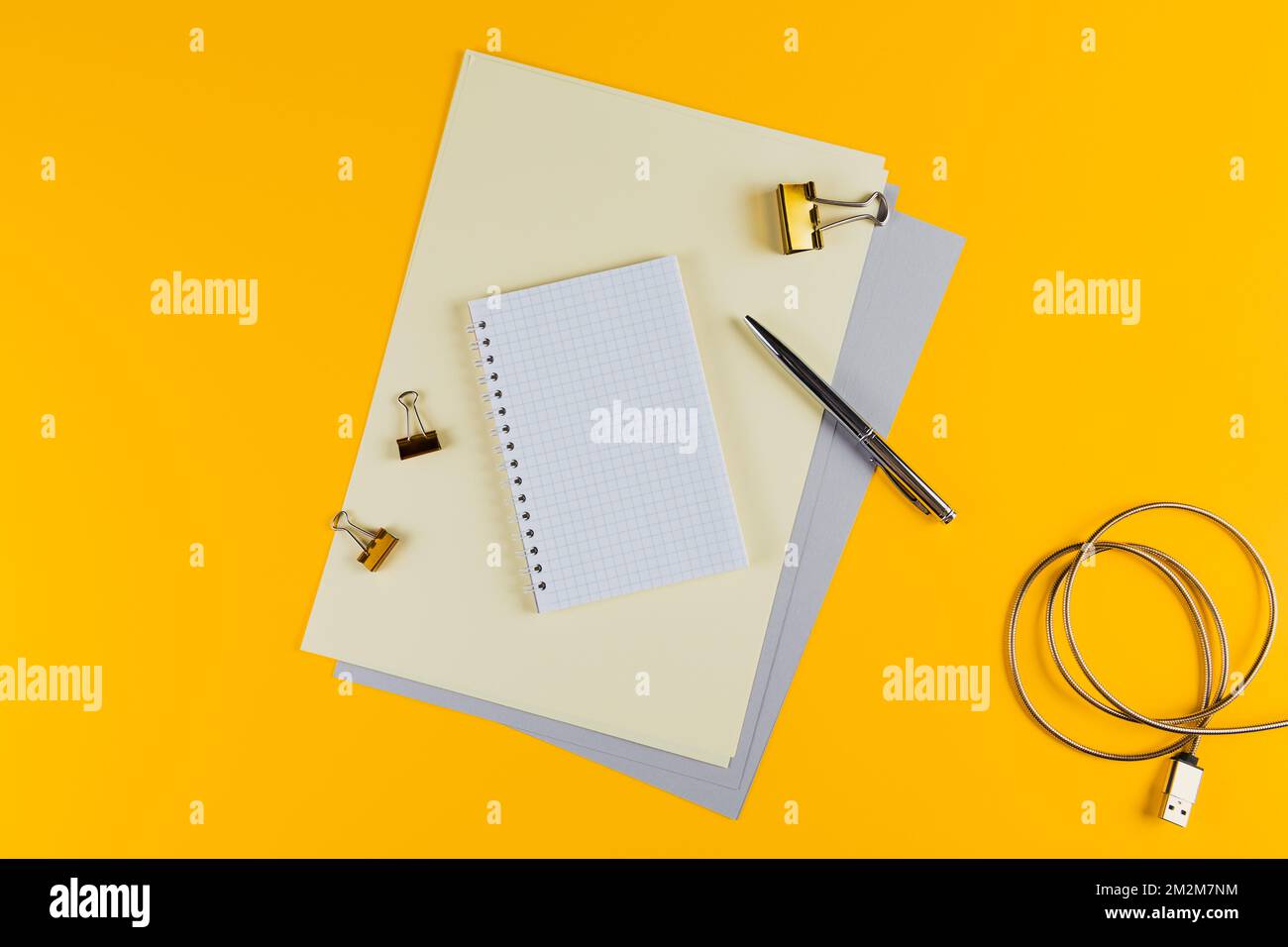 Yellow office desk table with blank notebook and other office supplies ...