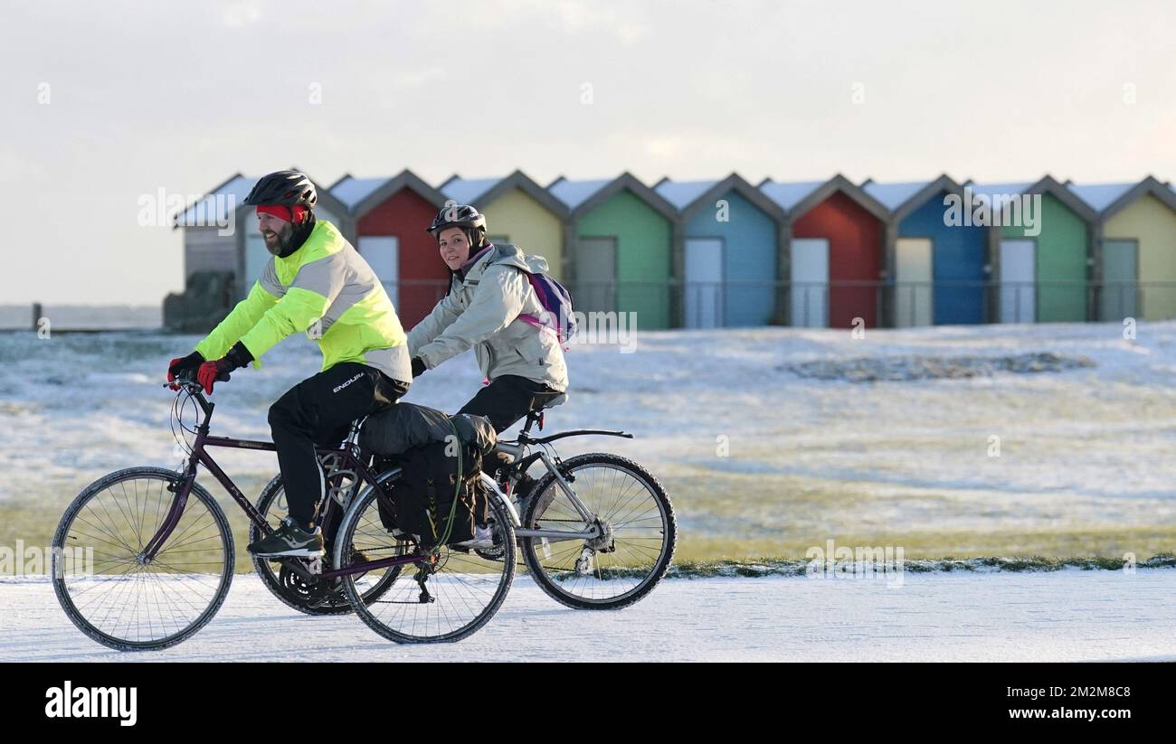 Cyclists near the beach huts on Blyth beach, Northumberland, on the ...