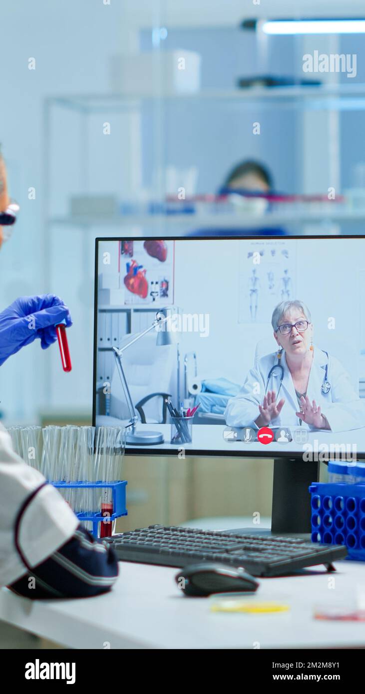 Scientist listening professional doctor on video call, discussing ...