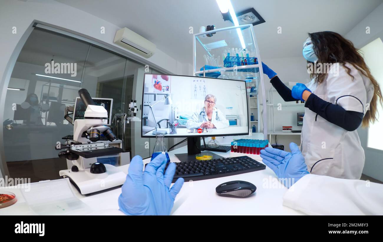 POV of scientist listening professional doctor on video call ...