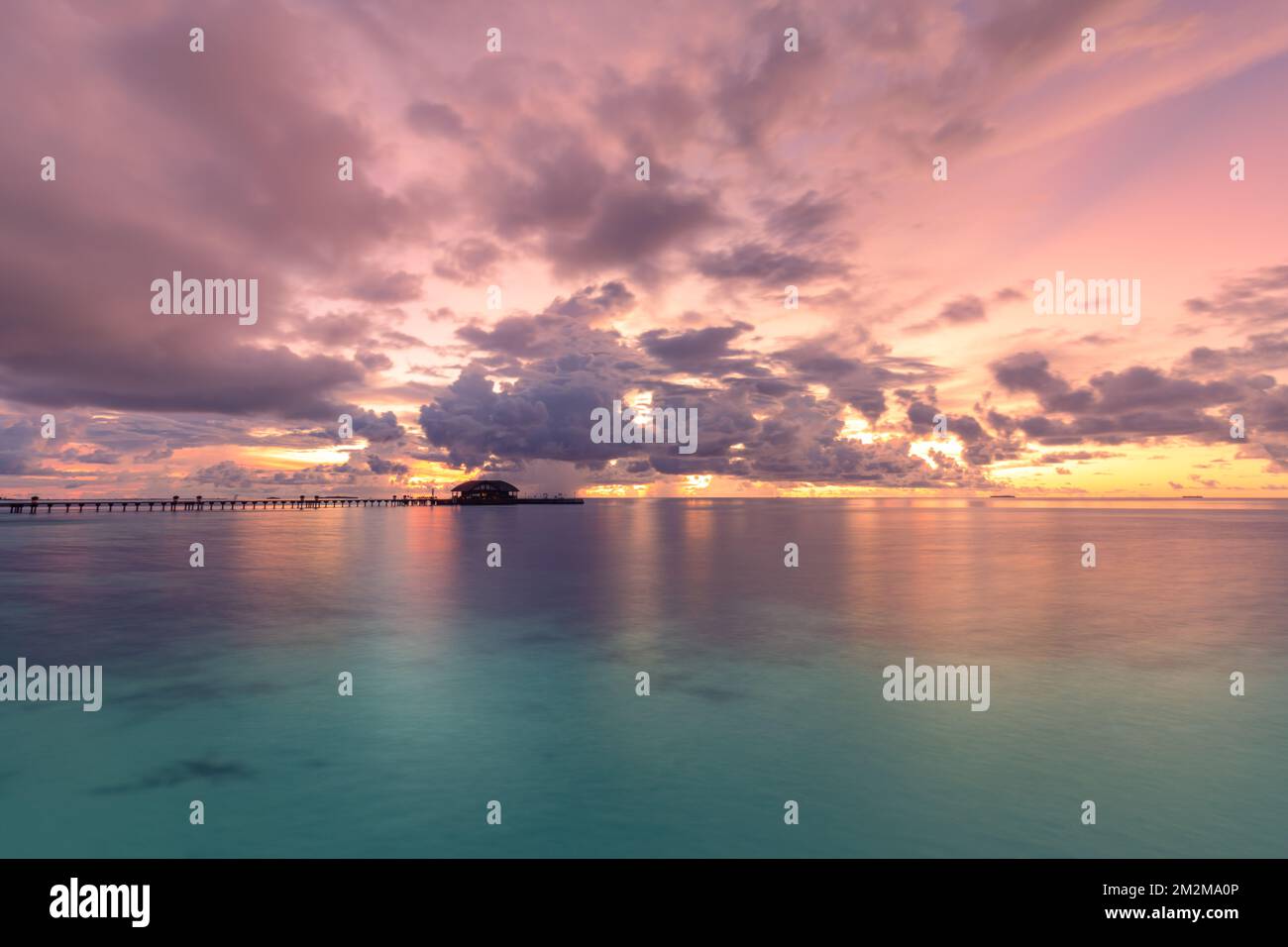Maldives resort island in sunset with wooden jetty, amazing colorful ...