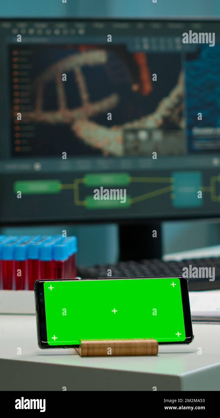 Horizontal mobile phone with green screen working in labooratory with ...