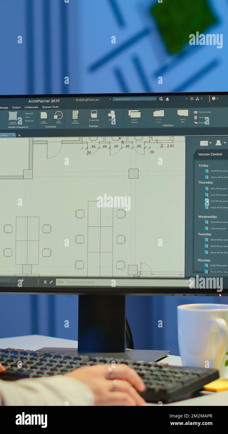 Over the shoulder shot of engineer working with architectural plans ...