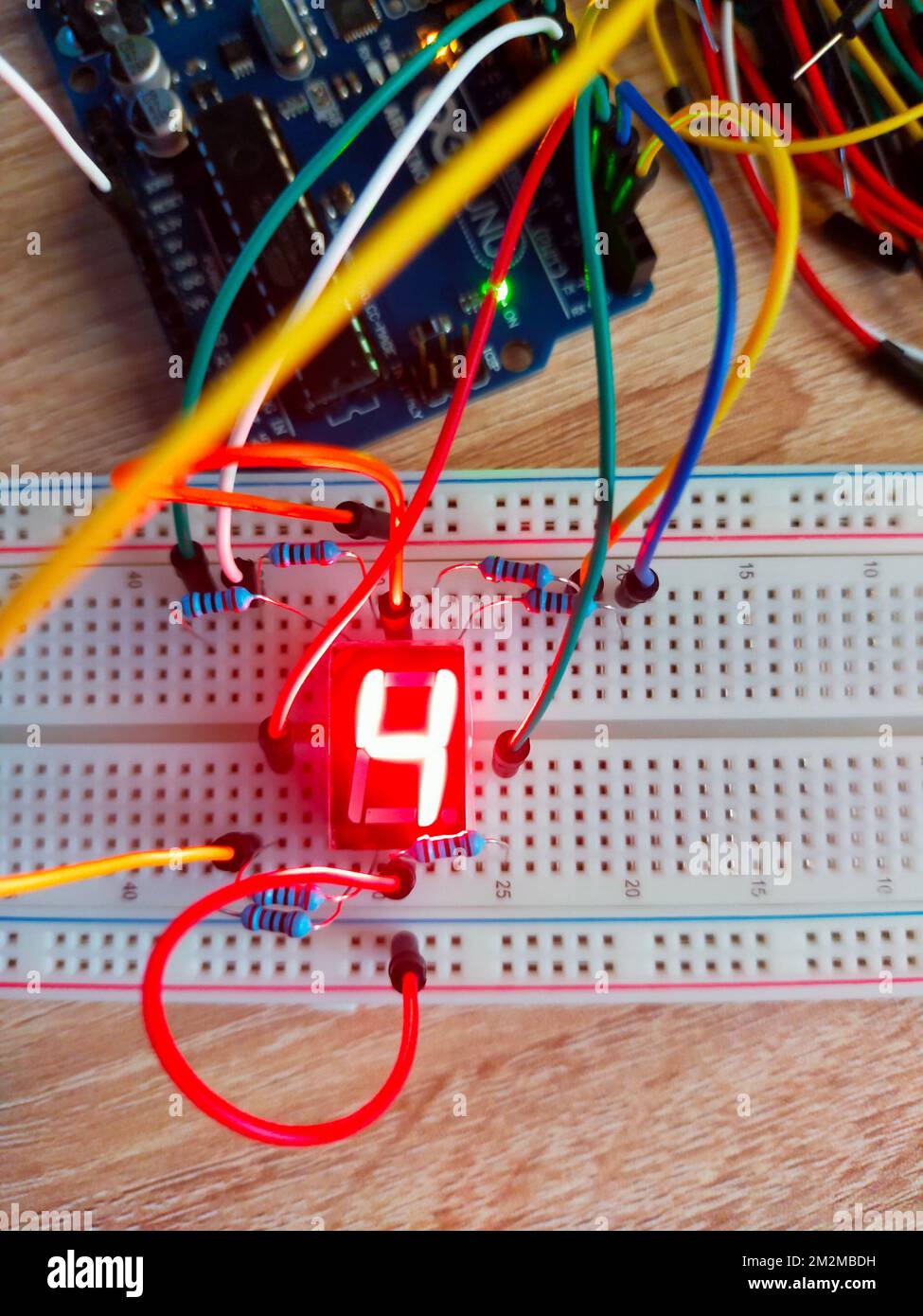 A vertical top view of number four on seven segment display breadboard ...