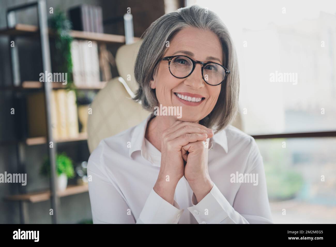 Photo of cheerful clever company owner lady sit leather chair hands ...