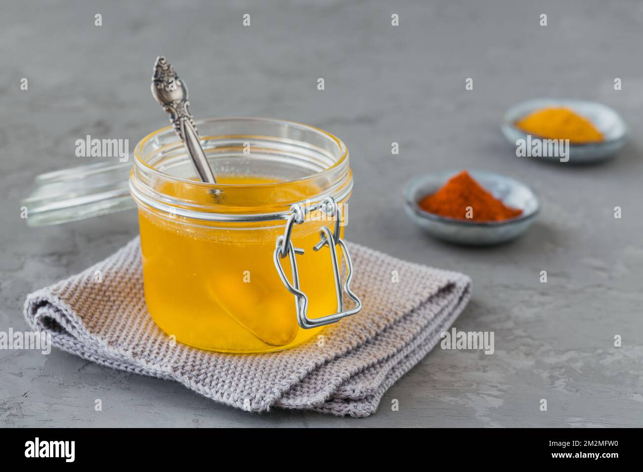 Healthy homemade Ghee or clarified butter in a jar, turmeric and ...