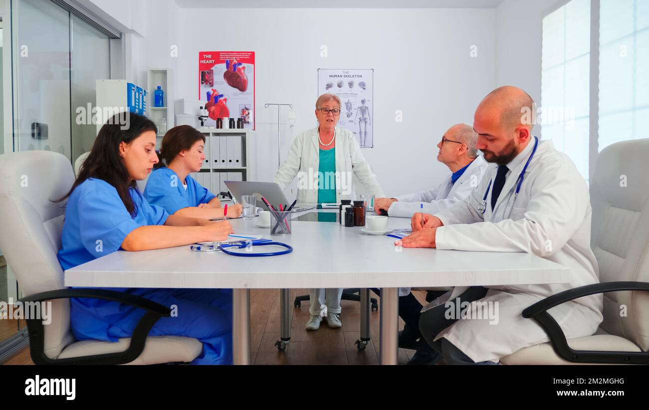 Nurses listening medical specialist during briefing about patient ...