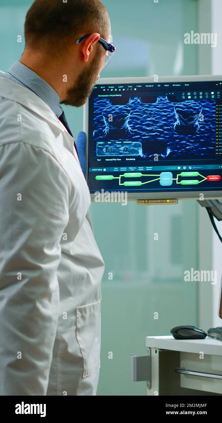 Scientist worried about virus evolution analysing DNA scan image ...