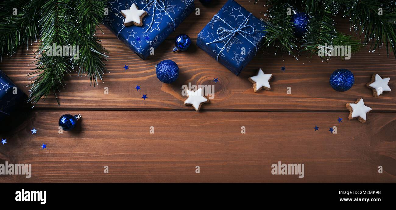 Christmas composition. Gifts, fir tree branches, blue decorations on ...