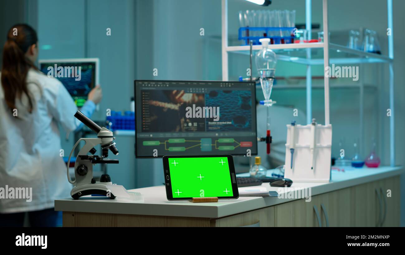 Tablet with green screen working in labooratory with mock up, chroma ...