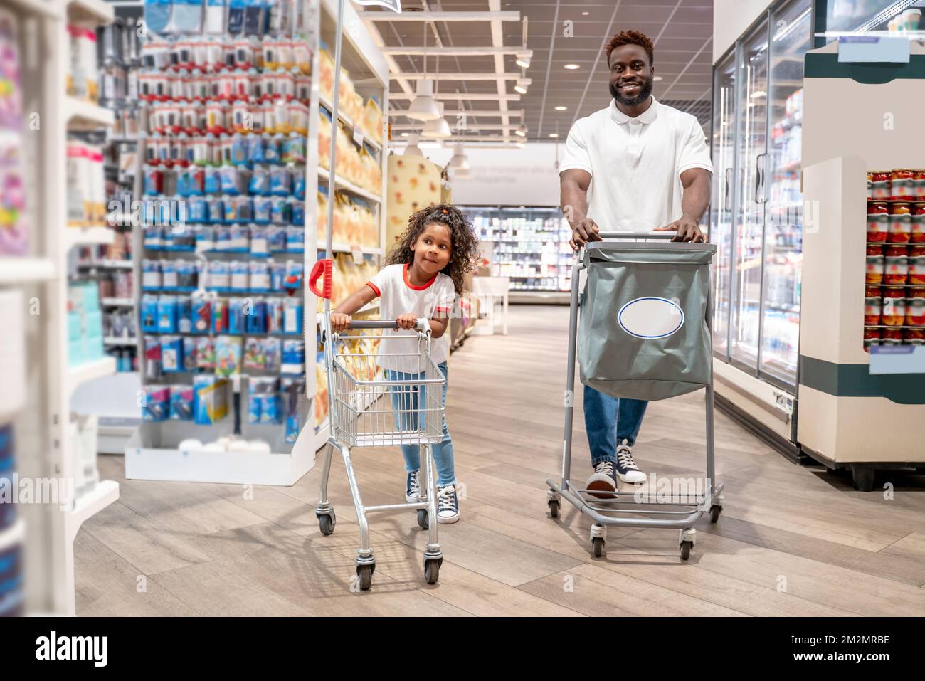 Dad and daughter on a food shopping in a supermarket Stock Photo - Alamy