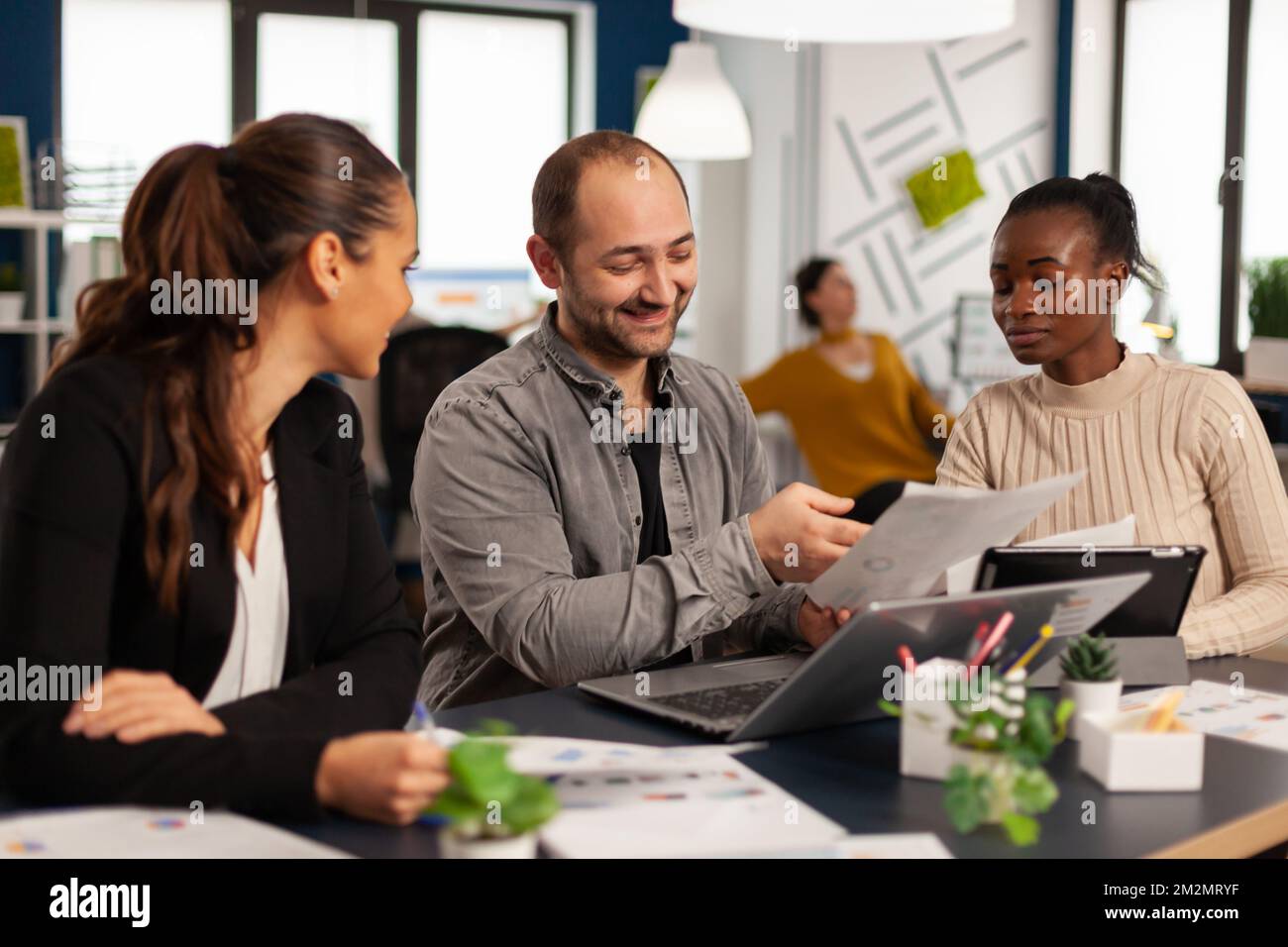 Business people analysing reports sitting hi-res stock photography and ...