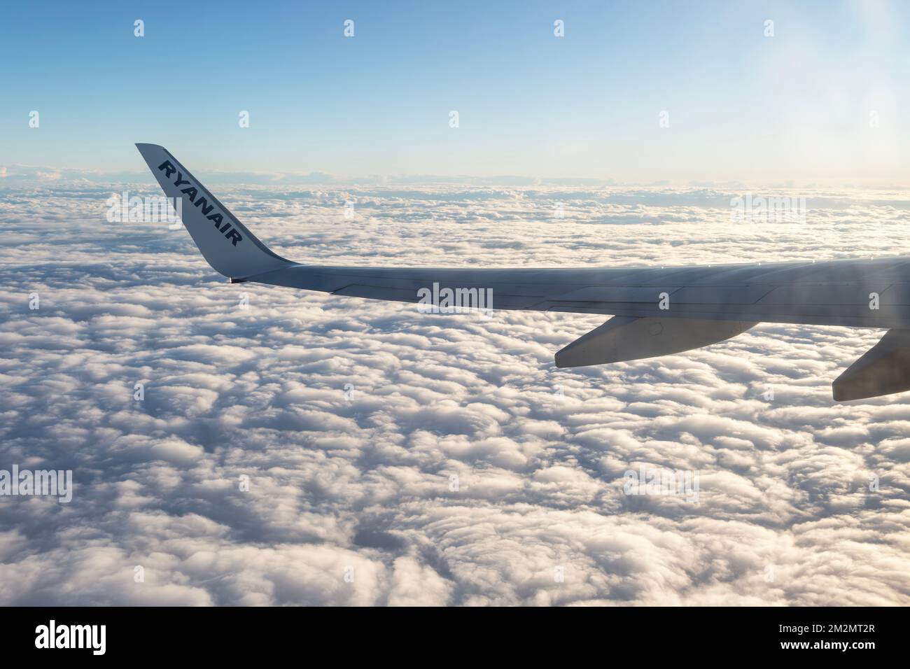 Wing of Ryanair airline Boeing 737 plane flying at high altitude above ...