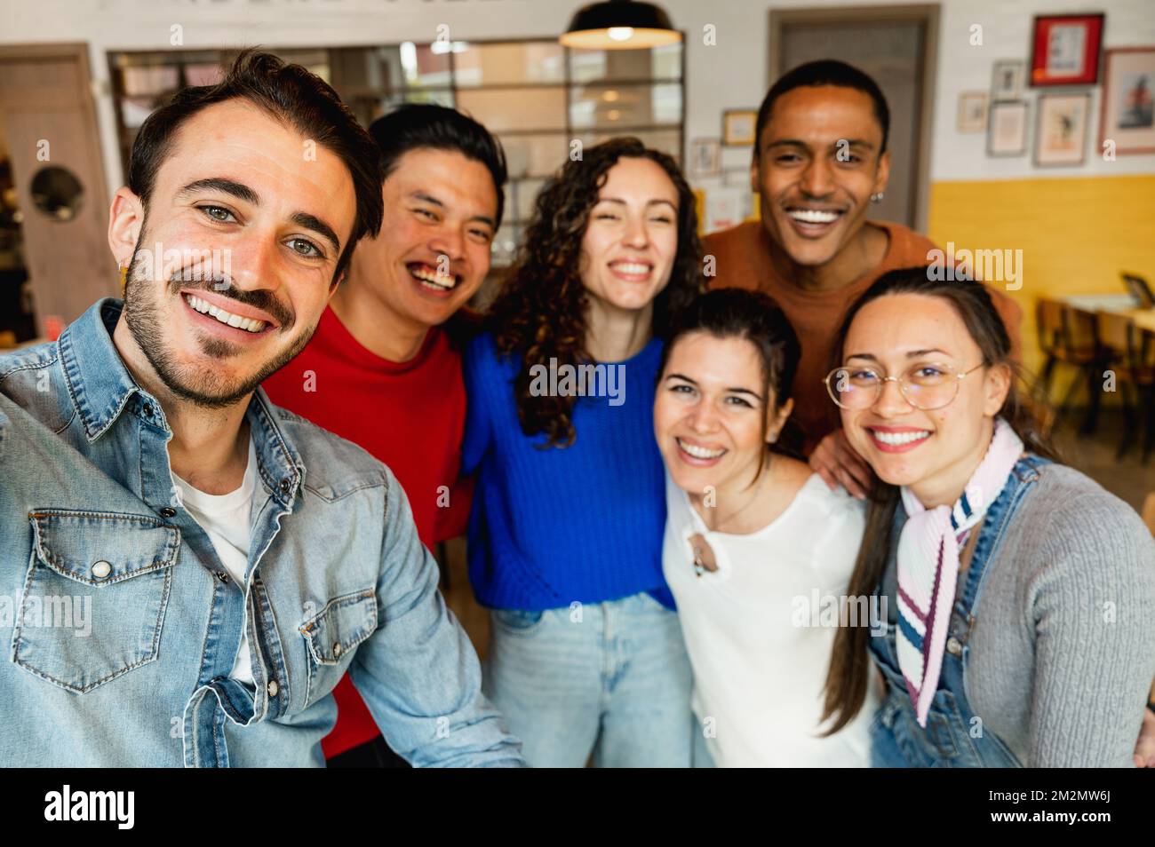 Group of six multiracial friends taking a selfie photo with smartphone ...