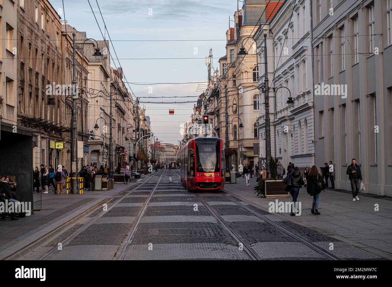 A crowd and the city center tram lines on a cloudy day Stock Photo - Alamy