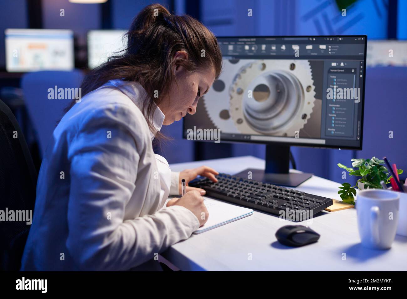 Woman engineer architect working in modern cad program sitting at desk ...
