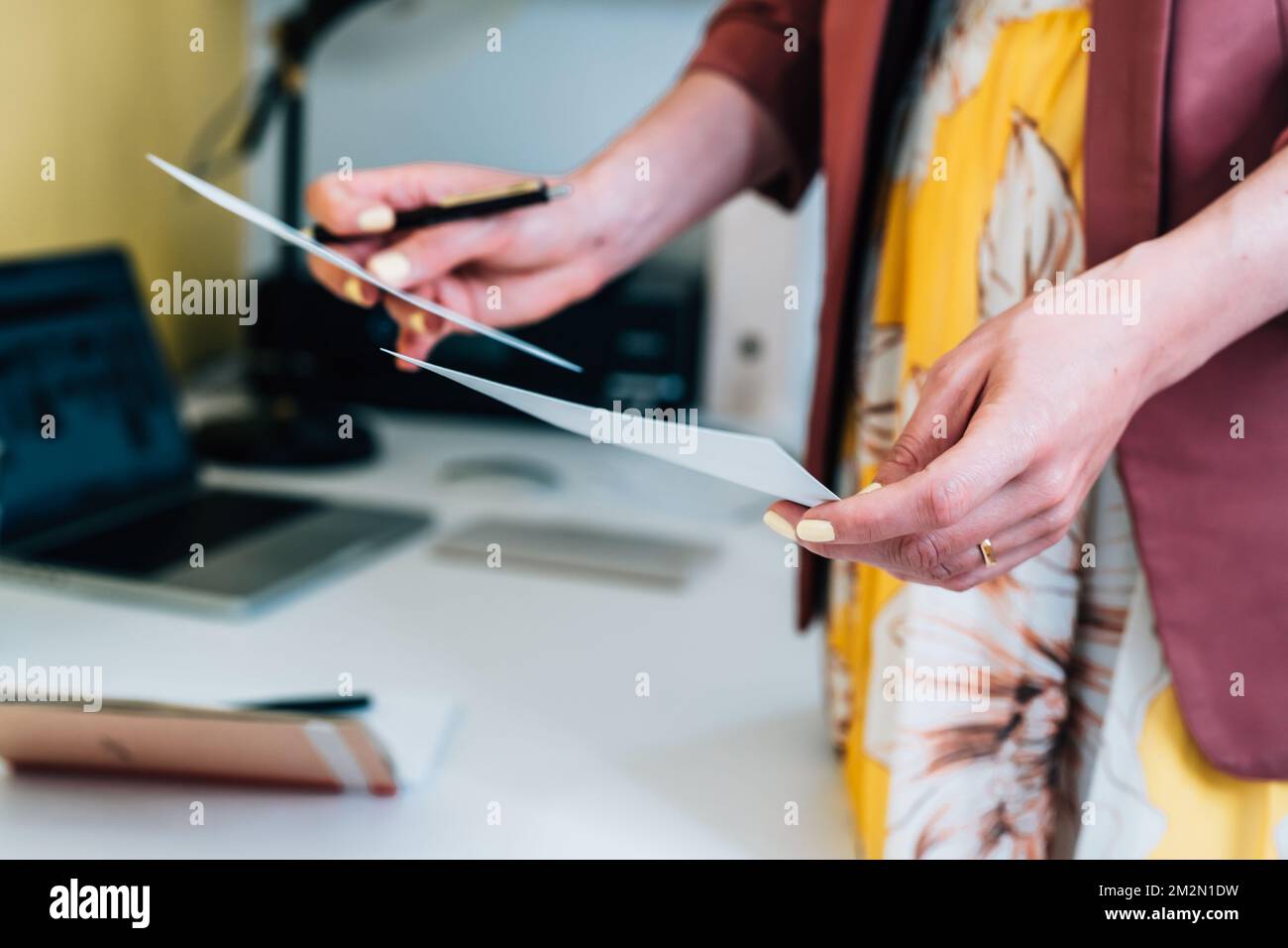 A closeup shot of a female comparing documents Stock Photo - Alamy