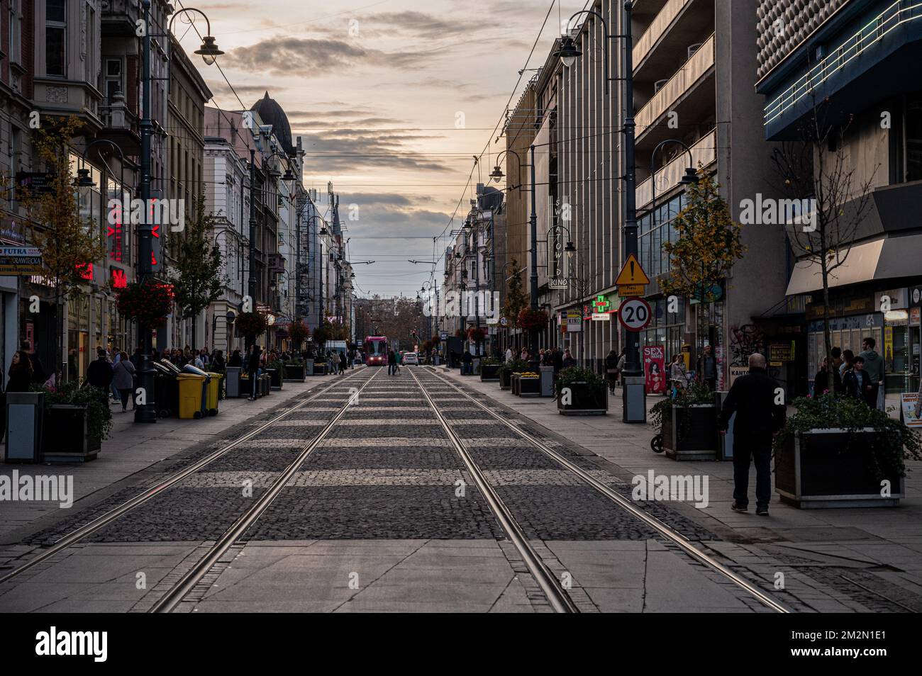 A crowd and the city center tram lines on a cloudy sunset Stock Photo ...