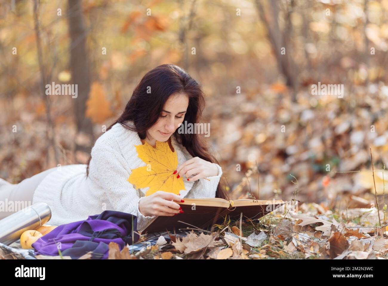 girl talks on the phone and looks away. portrait of a girl in autumn ...