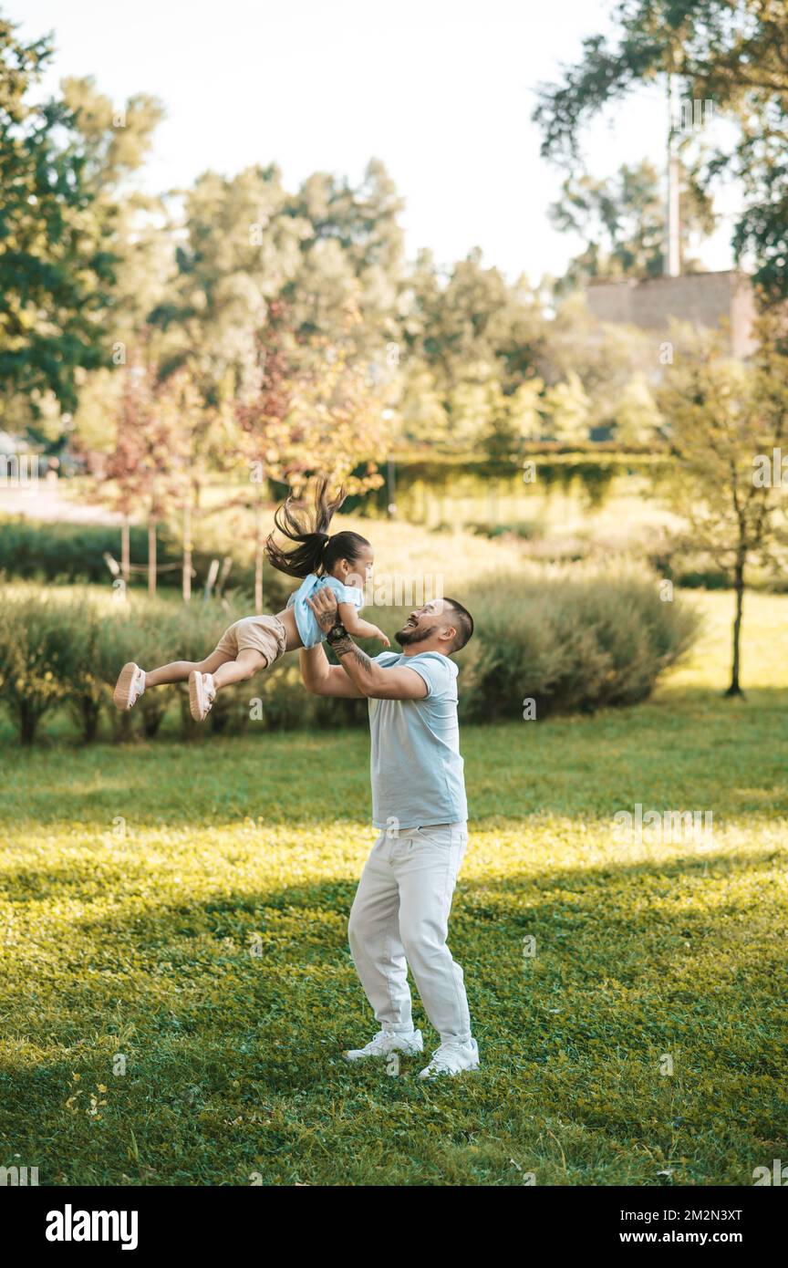 Dad and daughter having fun in the park and looking enjoyed Stock Photo ...