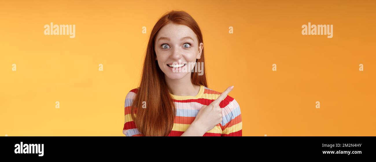 Excited thrilled good-looking young silly redhead girl surprised pop ...