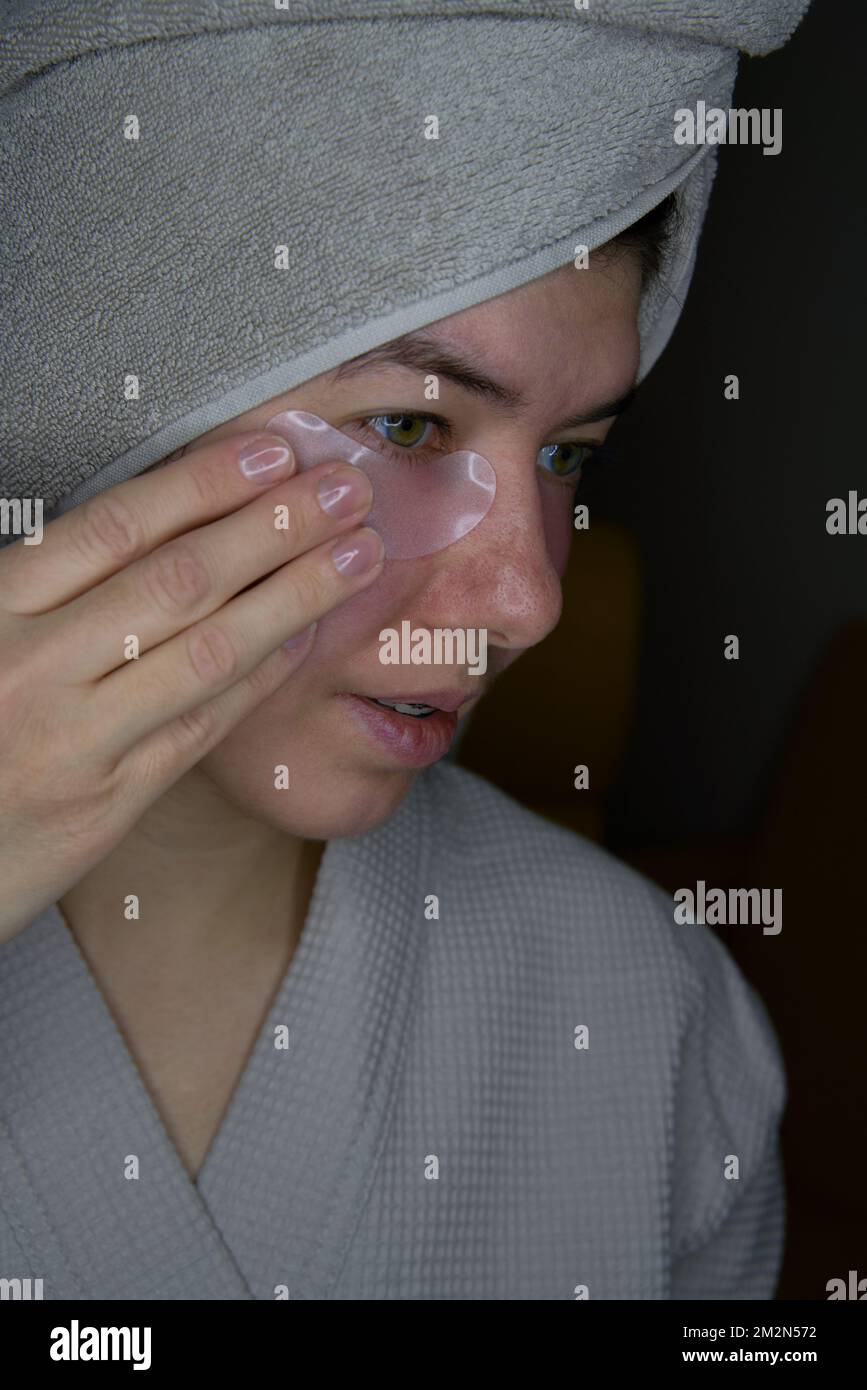 Woman with a towel over your head inflicts scrab on her face. Skin self ...