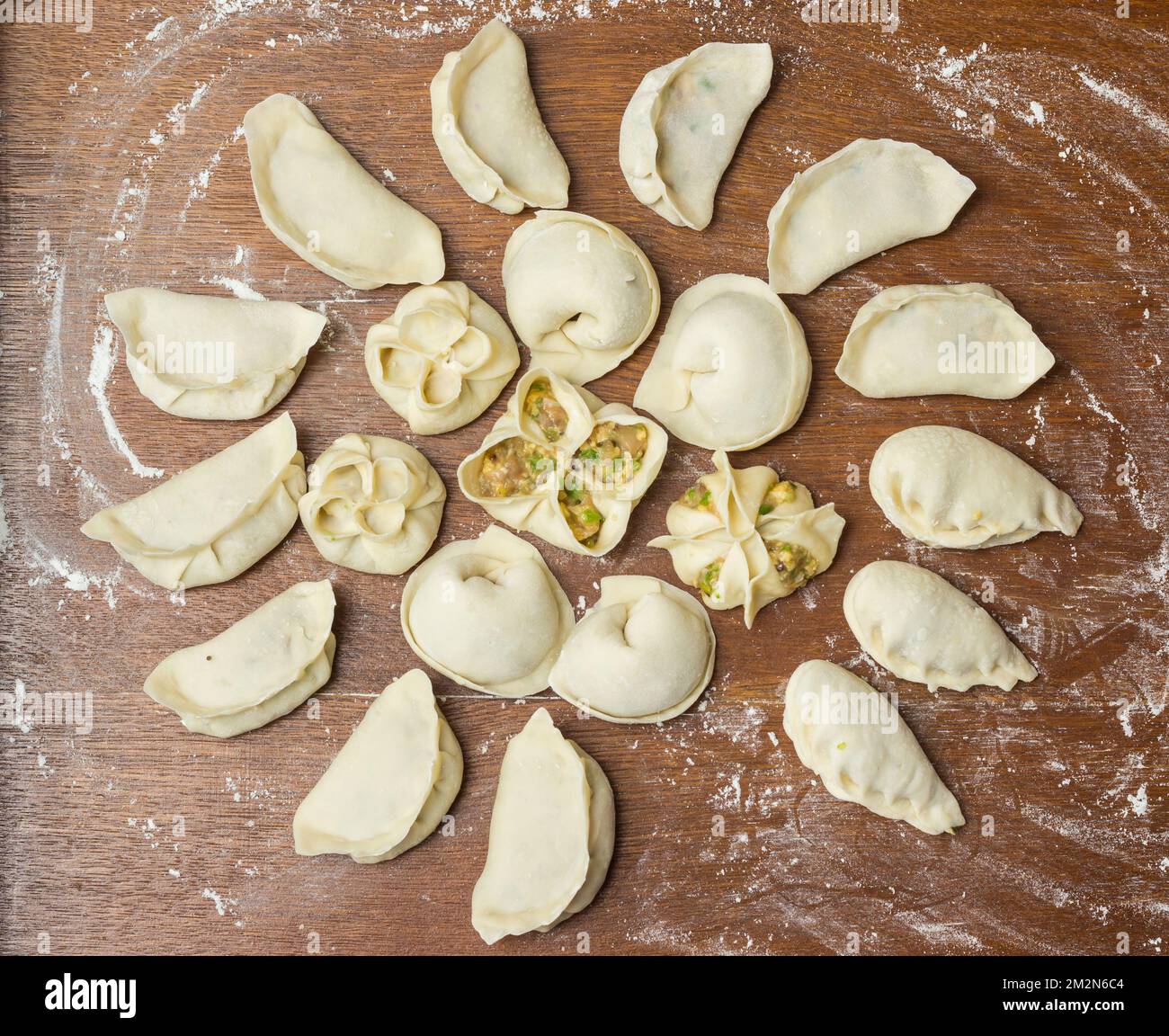 Traditional chinese dumplings in several forms and colors on a wooden ...