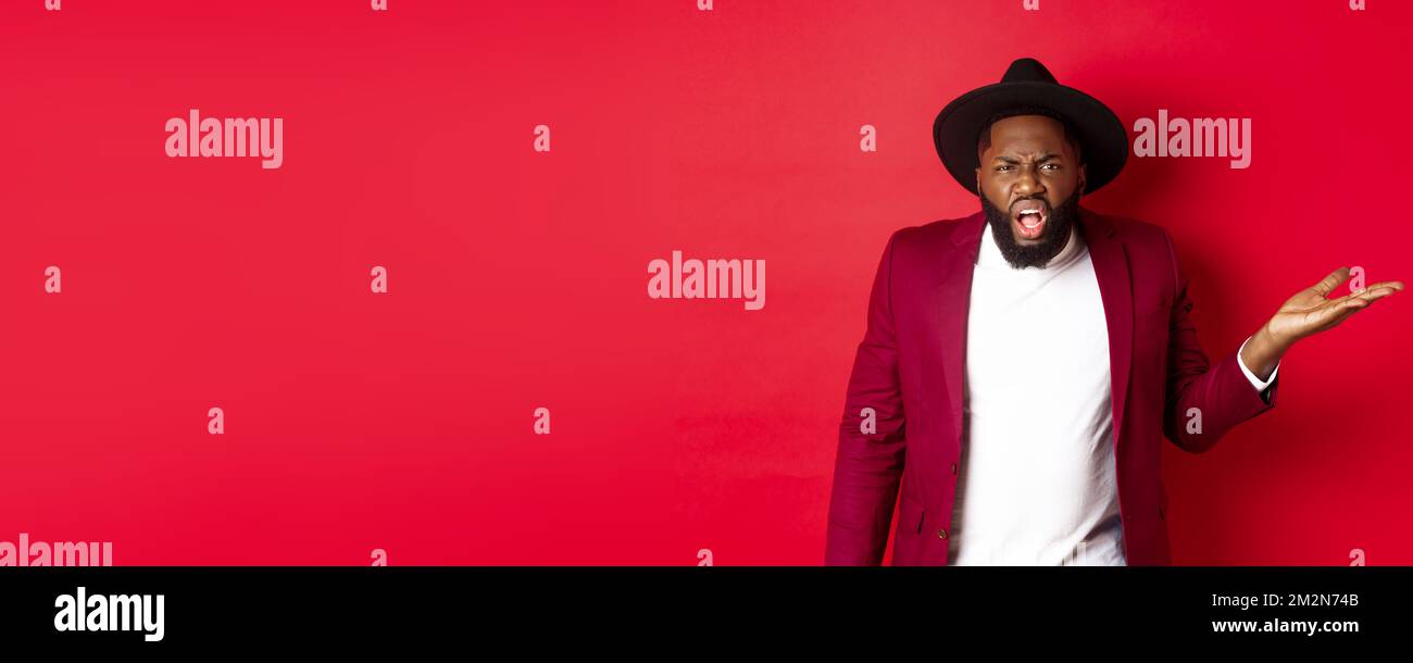 Angry and confused Black man arguing, shouting at camera and raising ...