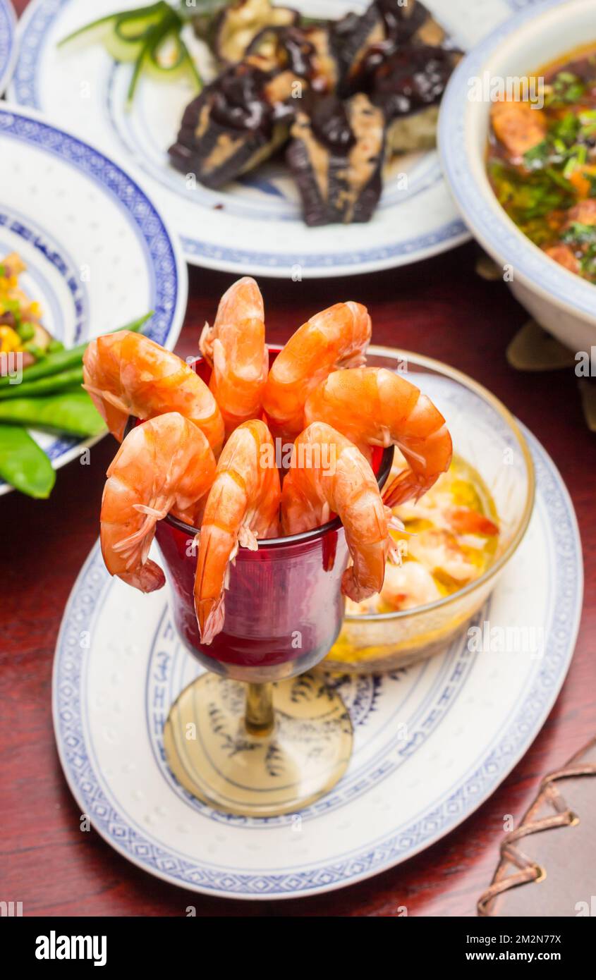 Glass filled with cooked shrimp on a diner table Stock Photo - Alamy