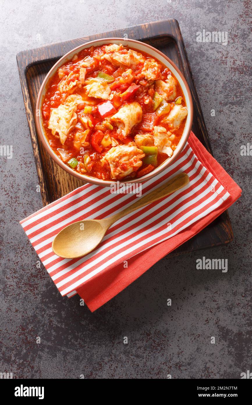 Spanish style salted cod cooked with vegetables peppers, tomatoes, and ...