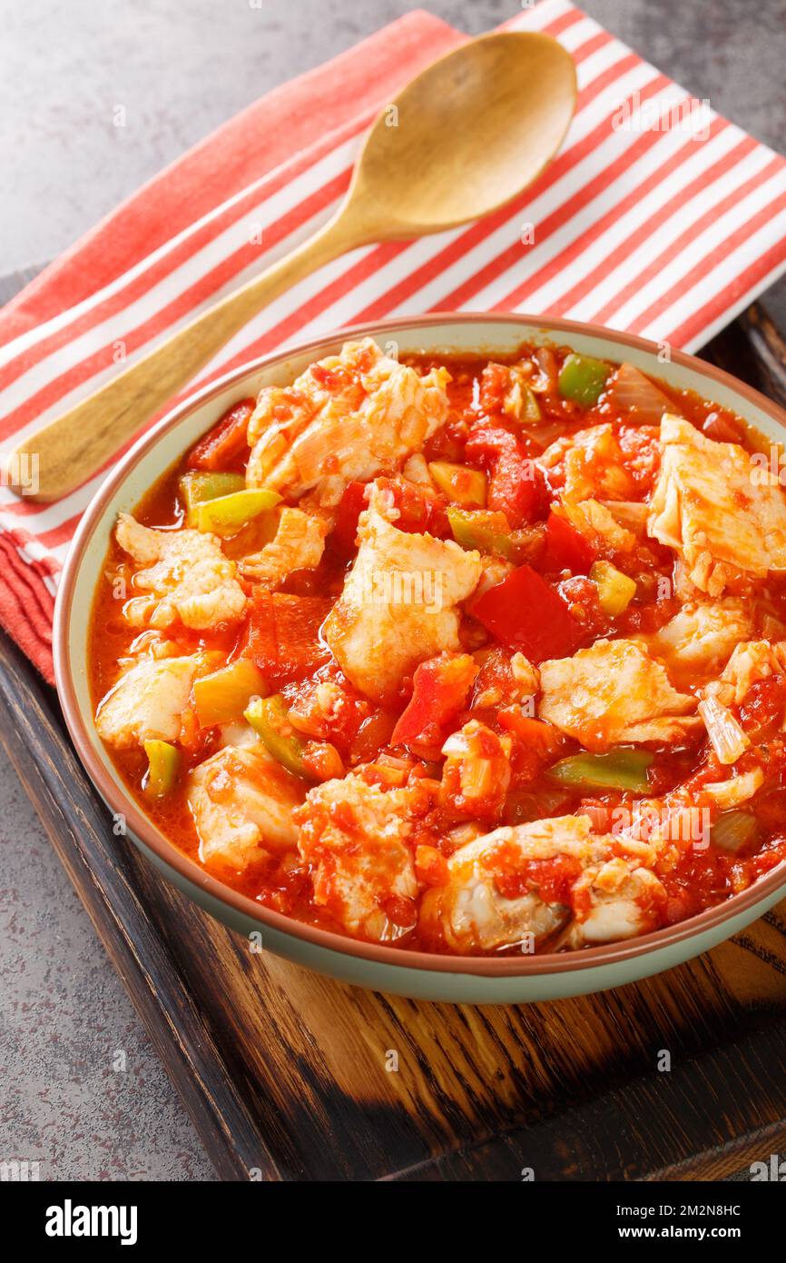 Spanish style salted cod cooked with vegetables peppers, tomatoes, and ...