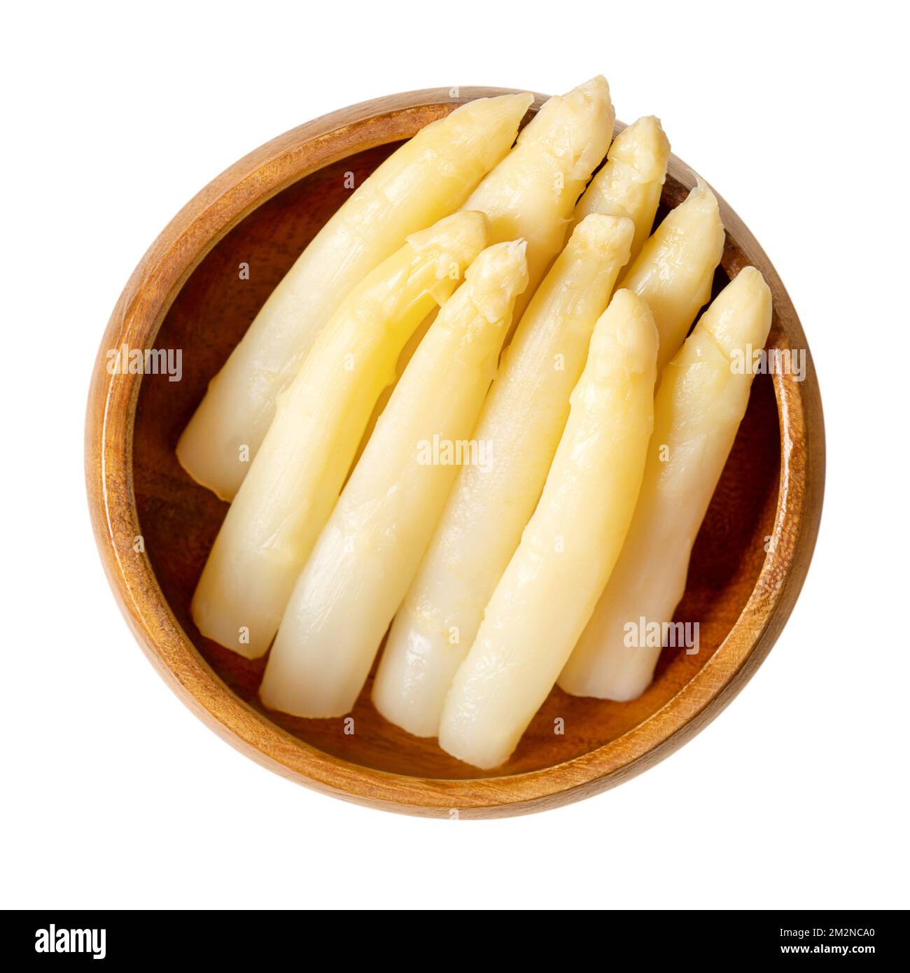 Potted white asparagus tips in a wooden bowl. Group of white, blanched Asparagus officinalis ...