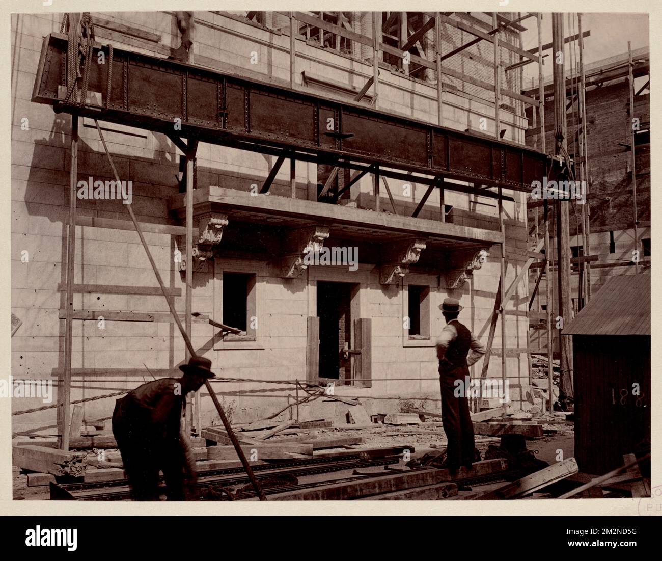 East wall of courtyard showing girder and balcony, construction of the ...