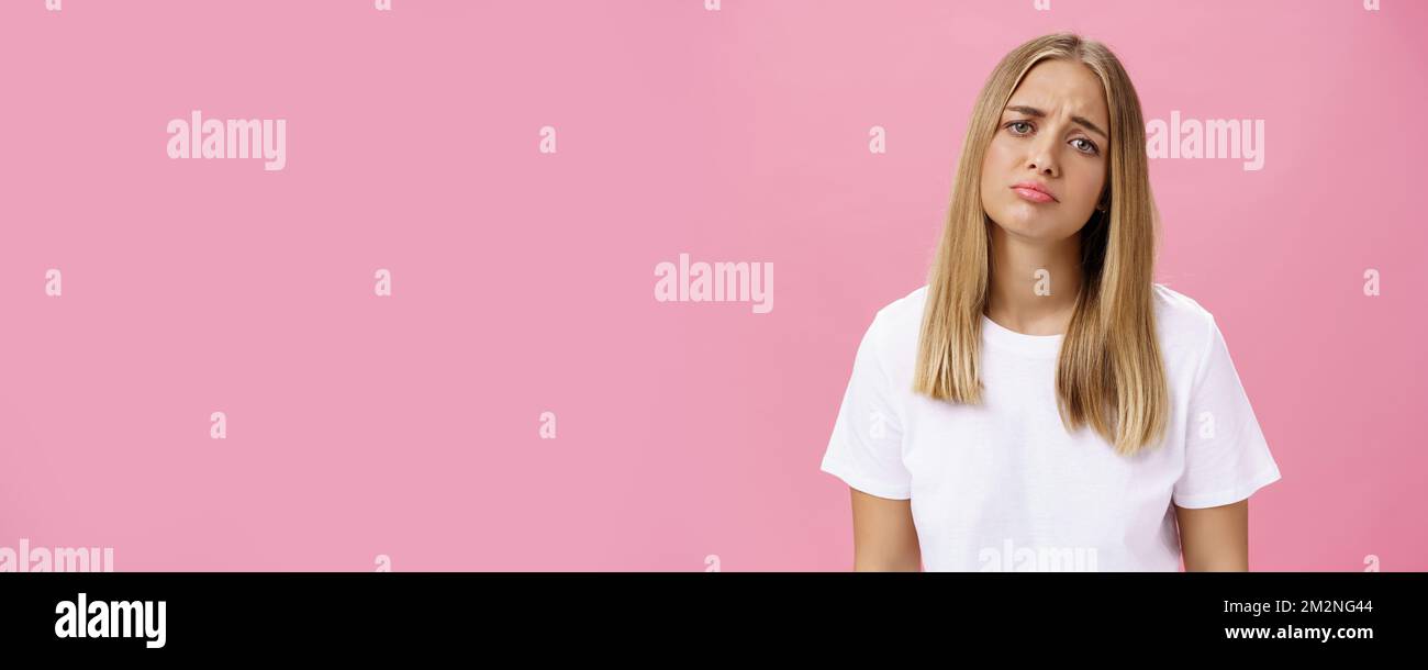 Sad girl whining tilting head raising eyebrows in upset expression and ...