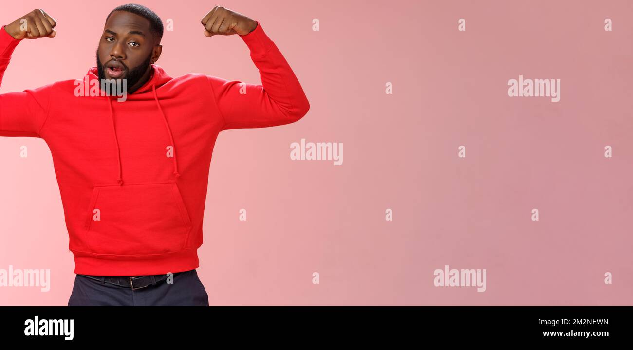Strong cheeky serious-looking african american sportsman in red hoodie ...