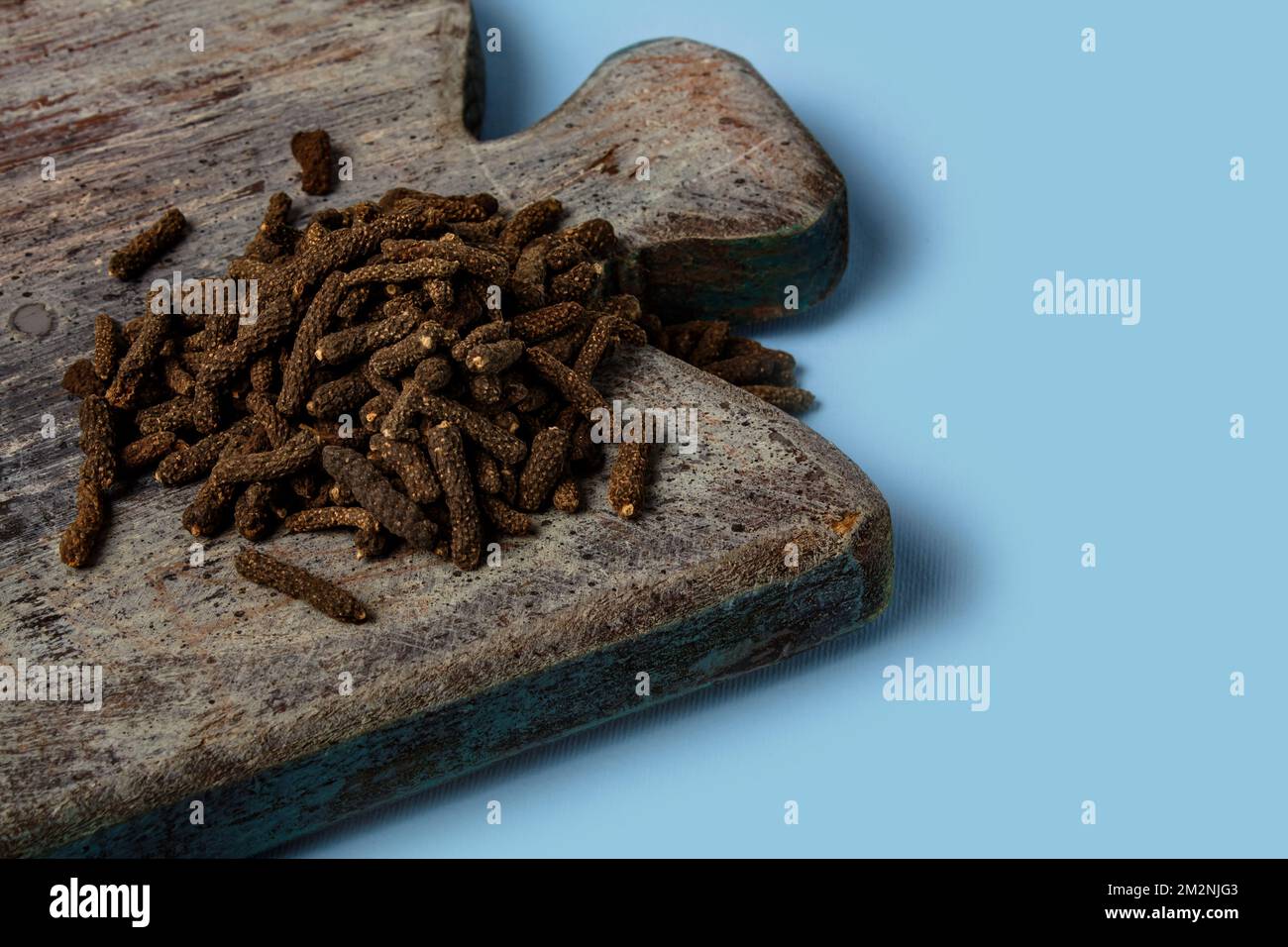 Dry Indian long pepper on a cutting board. Piper Longum ,Piper ...