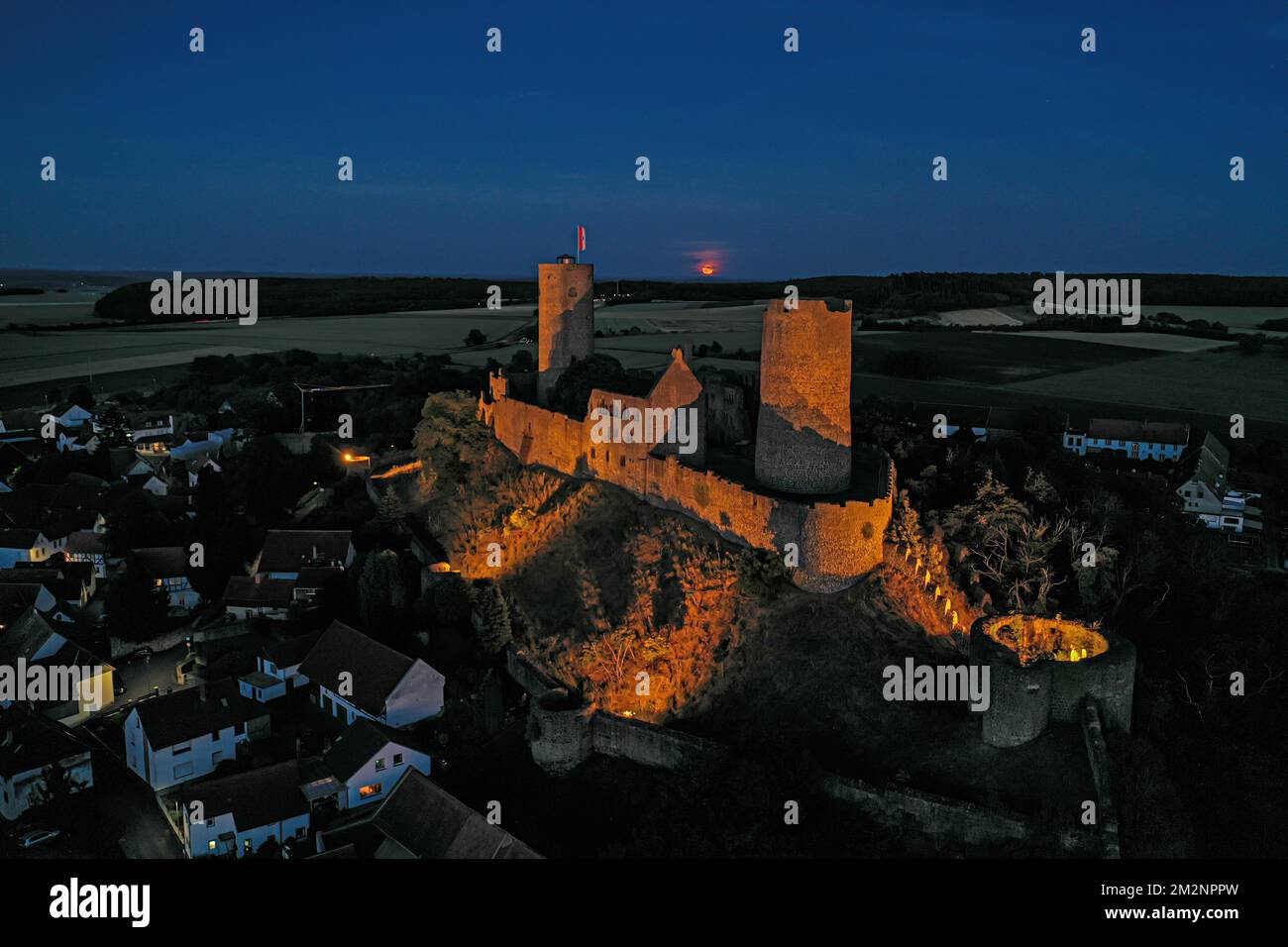 Image of illuminated Muenzenberg castle ruins in Germany in the evening ...