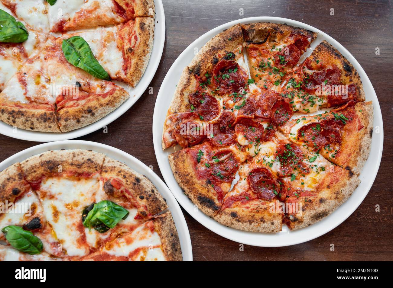 Top view three delicious Italian pizzas on the table Stock Photo - Alamy