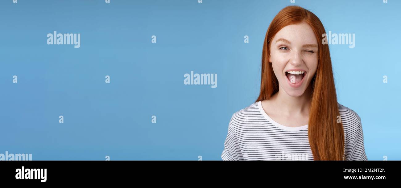 Cheeky good-looking flirty young gorgeous redhead girlfriend winking ...