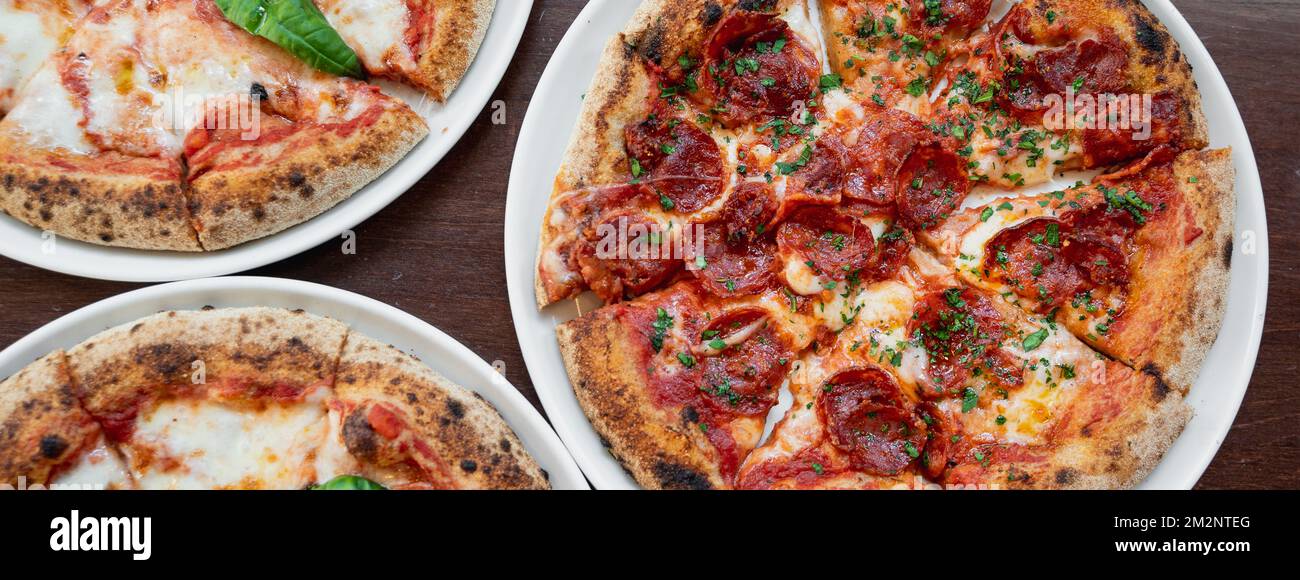 Horizontal banner or header Top view three delicious Italian pizzas on ...
