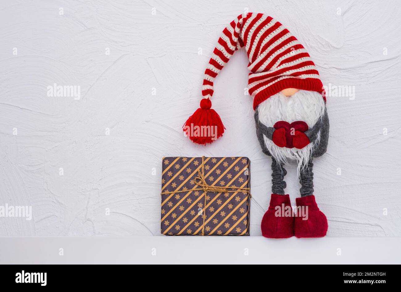 Christmas gnome in a striped hat with a heart in his hands. Decoration for Your Christmas. Gifts ...