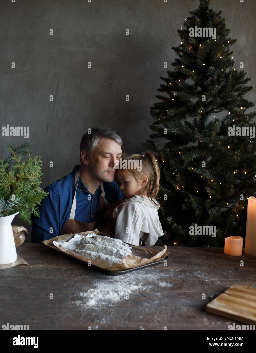 loving dad hugs little daughter while making Christmas pastries Stock ...