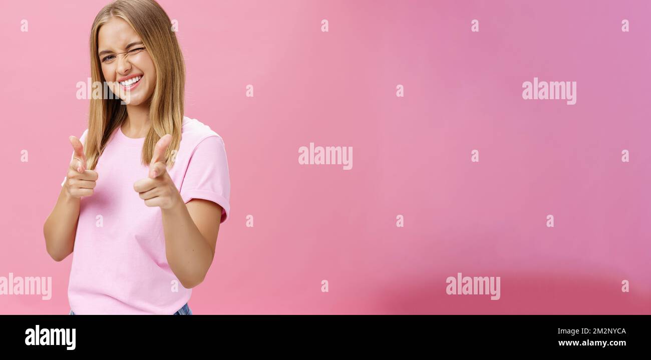 Woman expressing positive attitude towards camera pointing with fingers ...