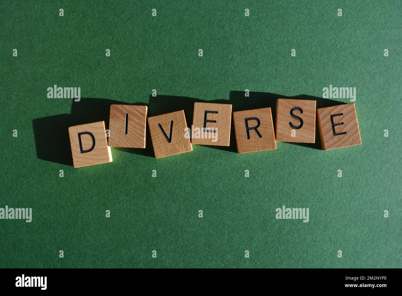 Diverse, word in alphabet letters isolated on green background as ...